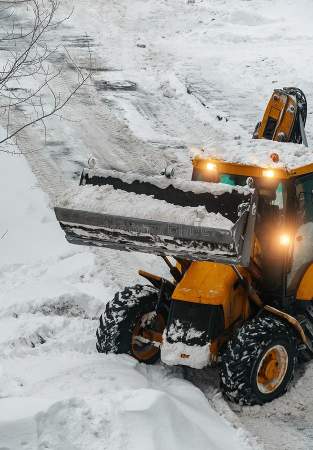 Tractor shoveling snow stock image. Image of lizzard - 264170081