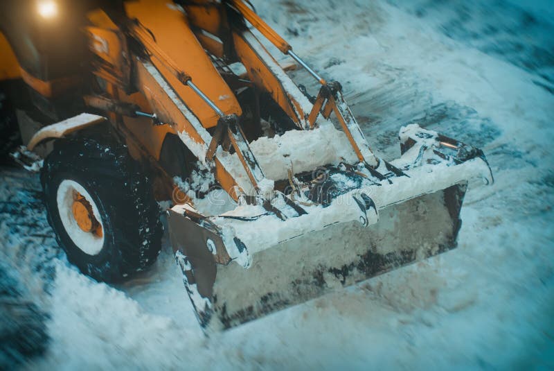 Tractor shoveling snow stock photo. Image of season - 264170120