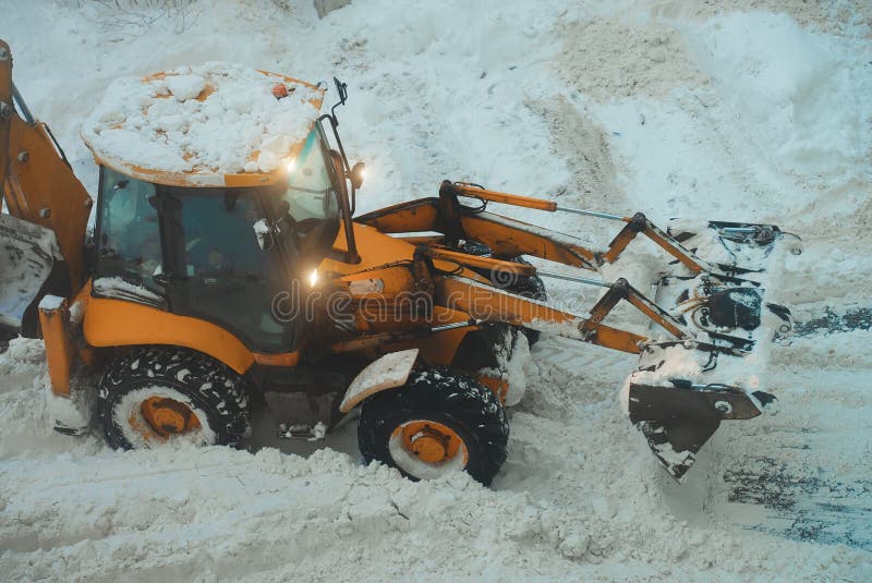 Tractor shoveling snow stock image. Image of excavator - 264170123