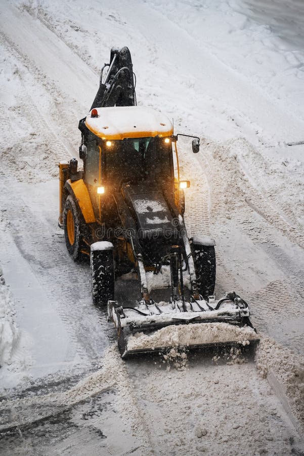 Tractor shoveling snow stock photo. Image of plow, service - 300250396