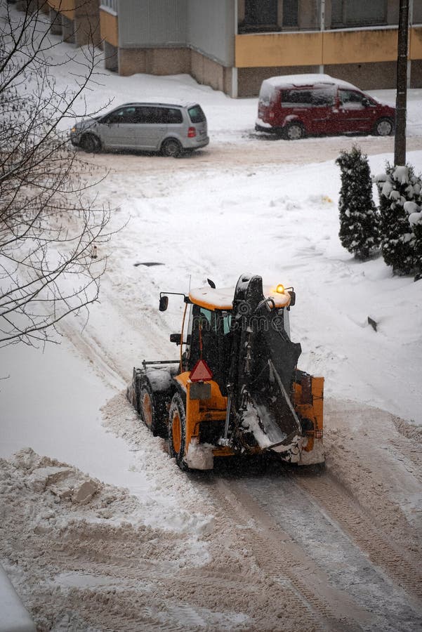 Tractor shoveling snow stock photo. Image of season - 300250420