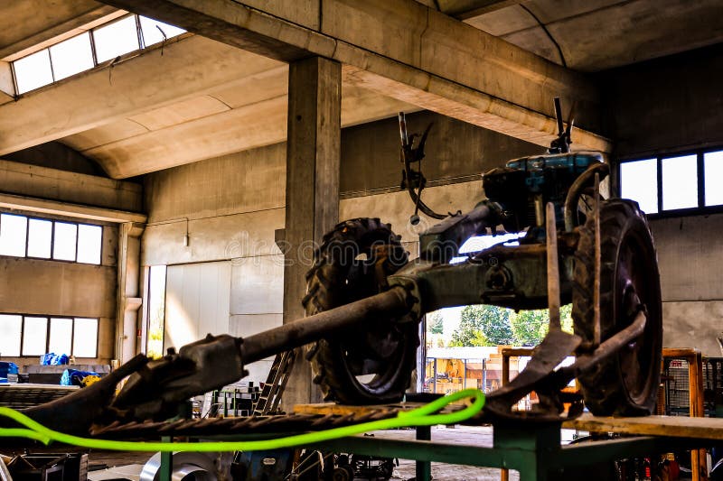 A Tractor is Sitting on a Table in a Large, Empty Building Stock Image ...