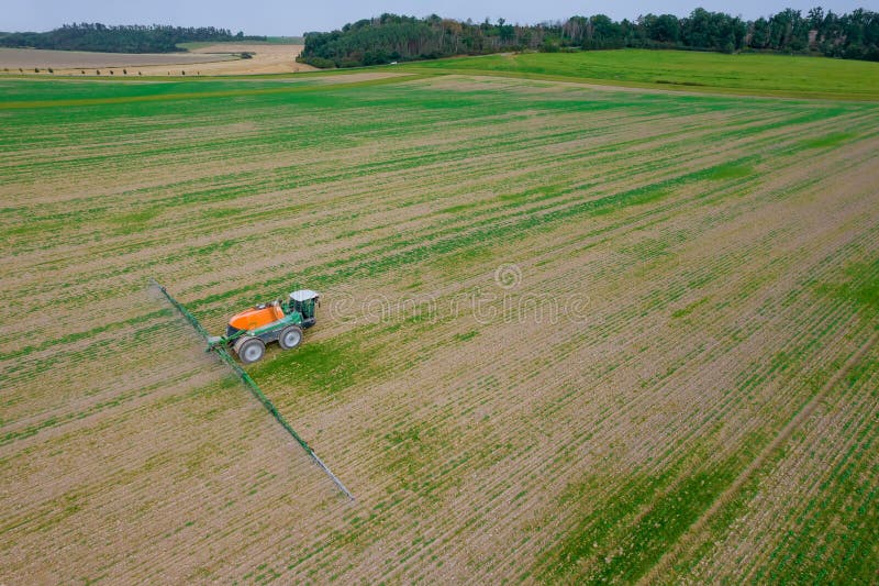 A Tractor with a Sprayer Processes the Field with Fertilizer ...