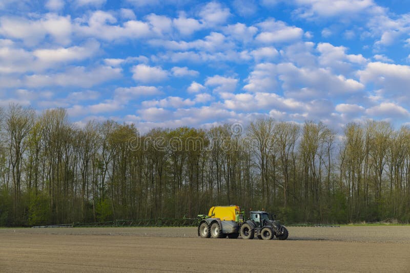 Tractor with a Sprayer during Spring Work in the Field Stock Image ...