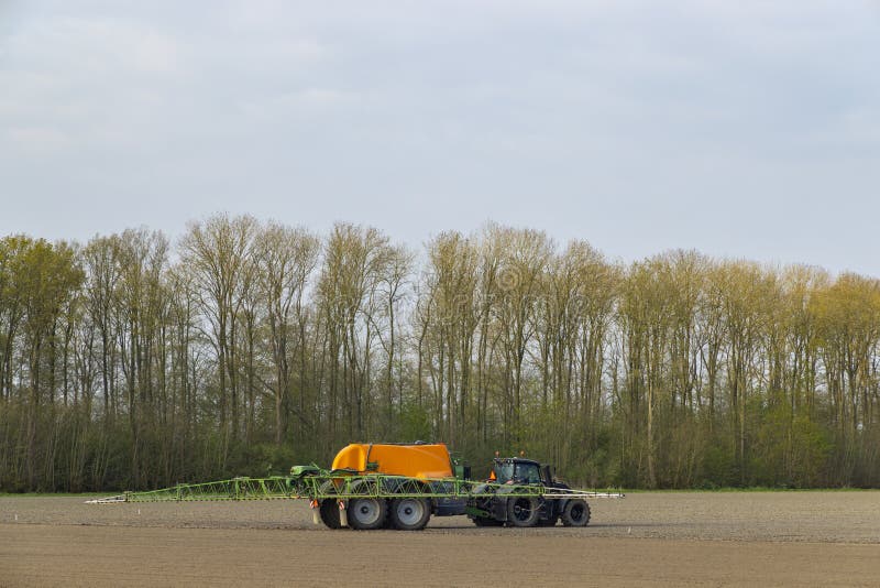 Tractor with a Sprayer during Spring Work in the Field Stock Image ...