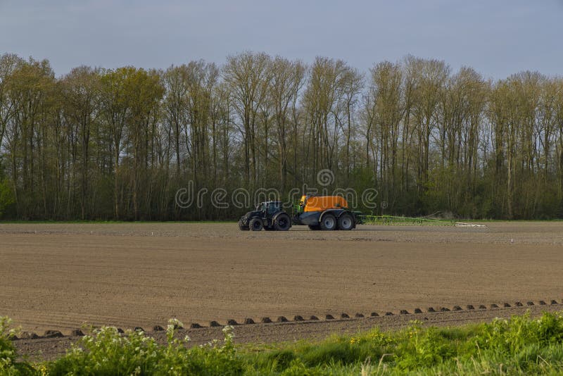 Tractor with Sprayer during Spring Work on the Field Stock Image ...