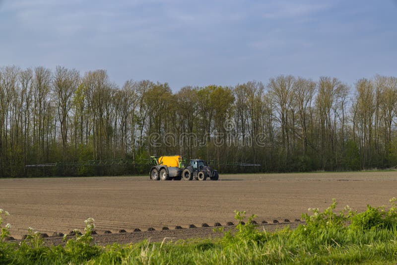 Tractor with Sprayer during Spring Work on the Field Stock Photo ...