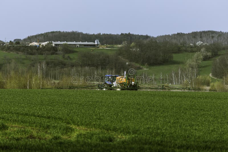Tractor spraying field stock photo. Image of outdoors - 84988442
