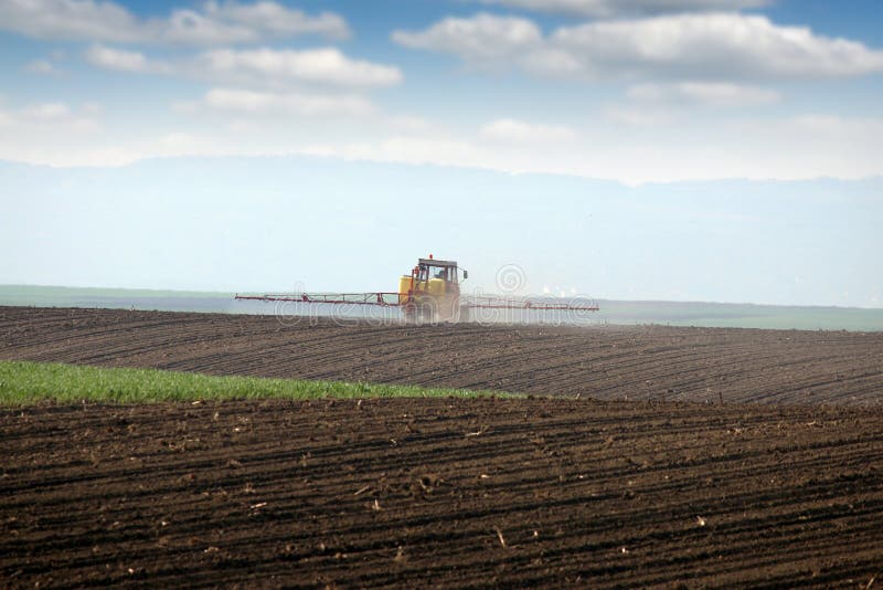 Tractor spraying field stock photo. Image of driving - 90866058