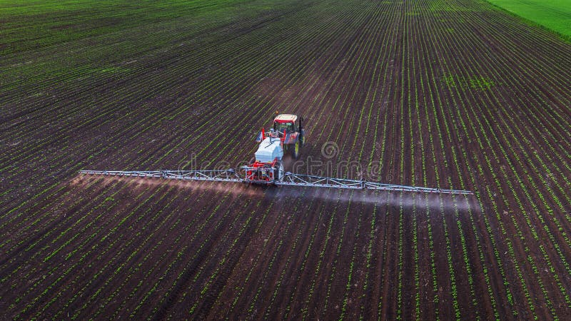Tractor Spraying Field at Spring Stock Image - Image of pesticides ...