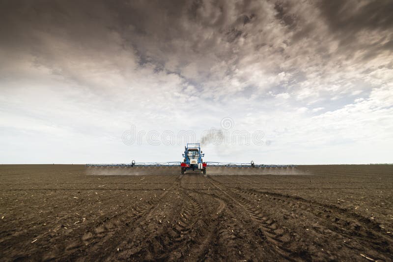 Tractor Spraying Soil in Field Stock Image - Image of rural, equipment ...
