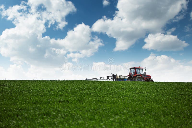 Tractor Spraying Wheat Field with Sprayer Stock Photo - Image of ...