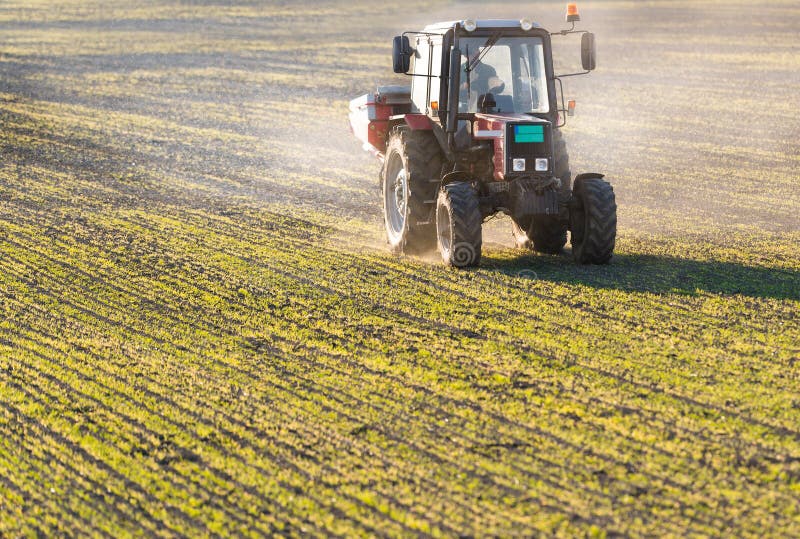 Tractor Spreading Artificial Fertilizers Stock Photo - Image of ...