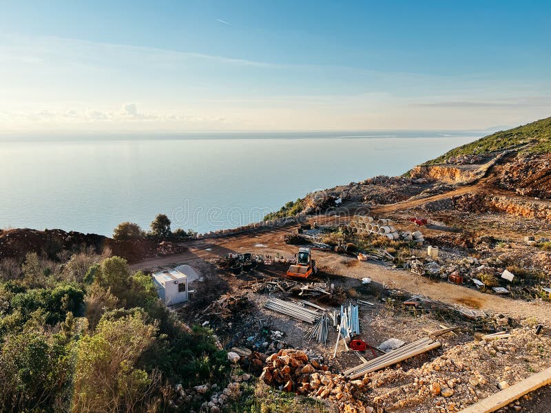 Tractor Stands on a Construction Site with Building Materials on a Hill ...
