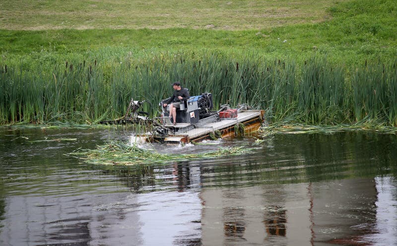 The Tractor Stands in the Tall Grass on the Shore of the Pond 08 17 ...