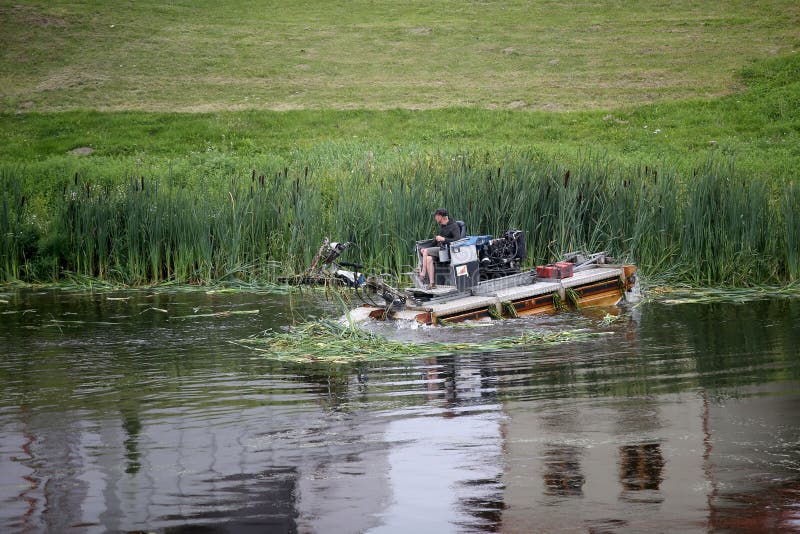 The Tractor Stands in the Tall Grass on the Shore of the Pond 08 17 ...