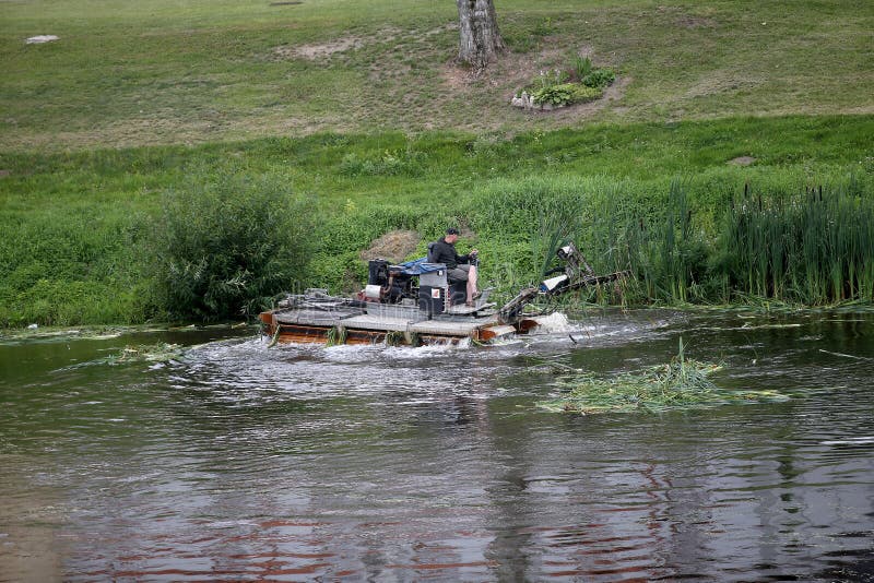 The Tractor Stands in the Tall Grass on the Shore of the Pond 08 17 ...