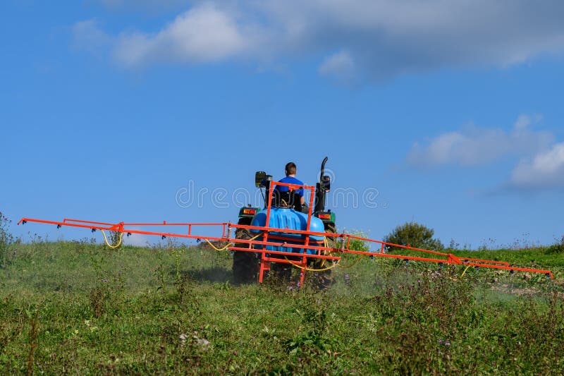 A Tractor with a Tank and Attached Equipment for Spraying the Field ...