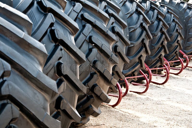 Old Tractor Tires Stacked Against Old Building Stock Photo - Image of ...