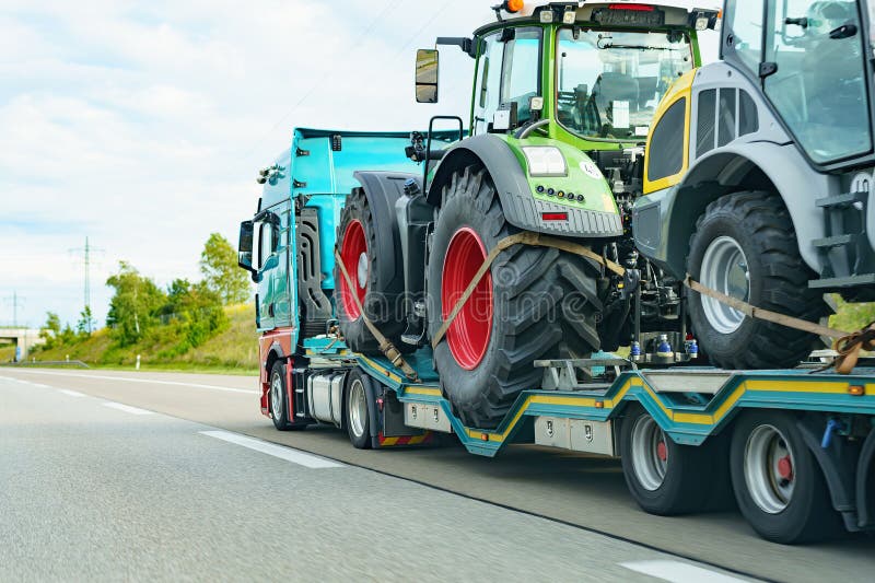 Tractor on a Tow Truck for Transportation by Road Stock Photo - Image ...