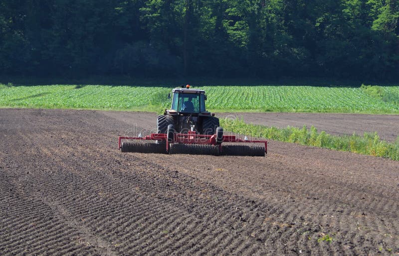 Tractor with a Towing Roller Compactor Makes the Surface of the Plowed ...