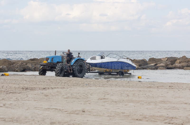 Tractor with Trailer Launches the Boat into the Water Stock Image ...