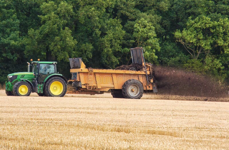 Tractor and Trailer Spreading Manure in a Field Stock Photo - Image of ...