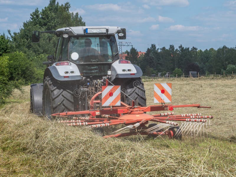 Tractor Turning Hay in a Field Editorial Photography - Image of ...
