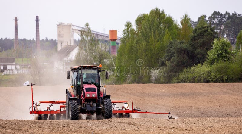 The Tractor is Used To Sow Seeds in the Field Using a Specialized Device. the Tractor is a ...
