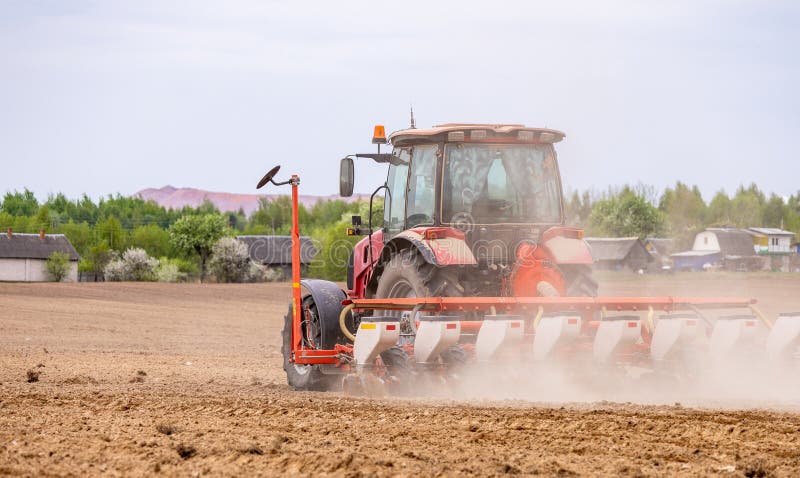 The Tractor is Used To Sow Seeds in the Field Using a Specialized Device. the Tractor is a ...