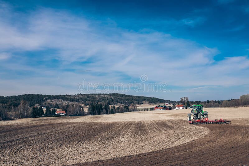 A Tractor Working in a Field Stock Image - Image of farming, norway ...