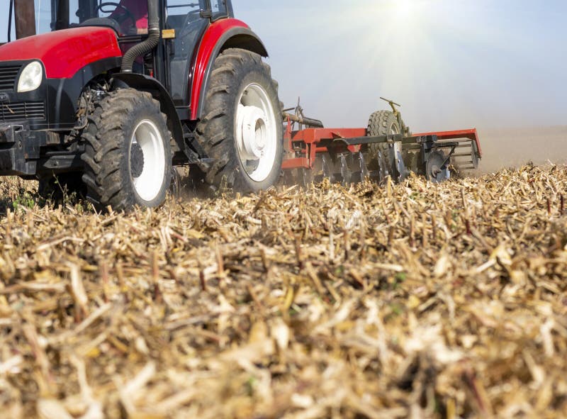 Tractor Working in the Field Stock Photo - Image of horizontal, flora ...