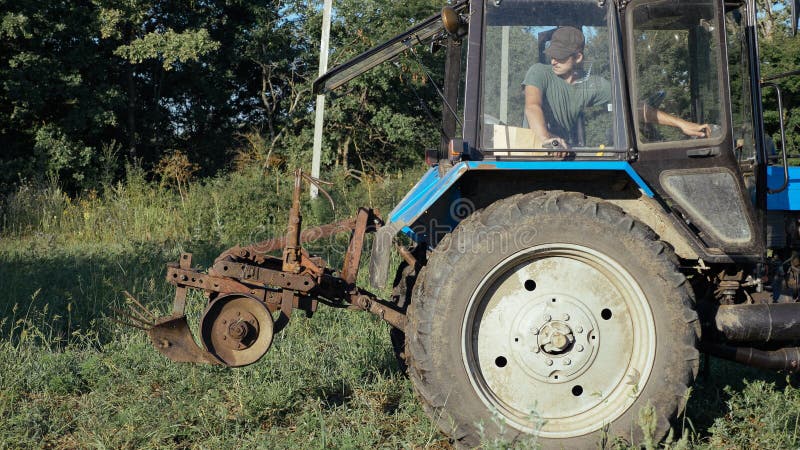 Tractor Working on the Potato Field. Harvesting Potatoes with Using ...