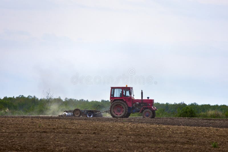 Tractor that Works the Land To Be Cultivated Stock Photo - Image of ...