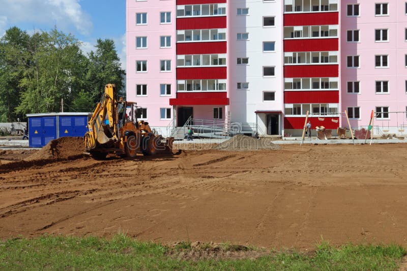 Tractor Works Near Building on Construction Site at Summer D Stock ...