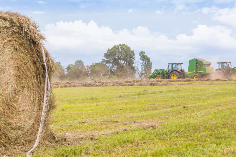 Tractors and Hay Roll in a Field Editorial Photography - Image of roll ...