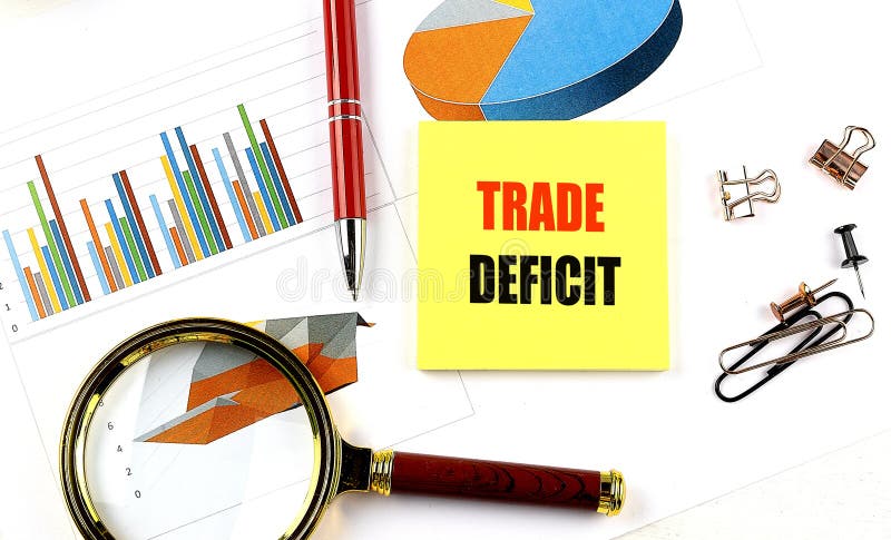 TRADE DEFICIT Text on Yellow Sticky on Chart with Magnifier and Pen ...