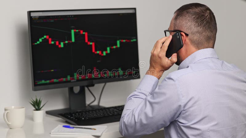 Trader is Monitoring Invest Analytics on the Monitor Screen. Stock ...