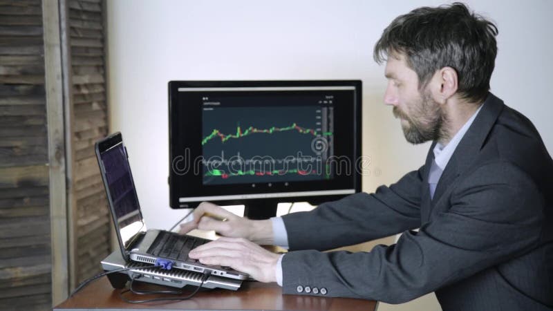 Trader Watching Changes in the Currency Exchange Chart, Looking at ...