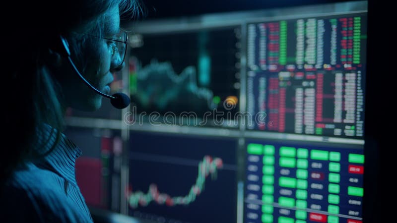 Trader is Working with Multiple Computer Screens with Charts and Data Analysis and Stock Broker ...