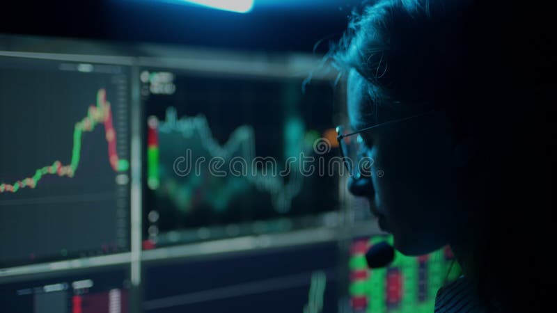 Trader Is Working With Multiple Computer Screens With Charts And Data