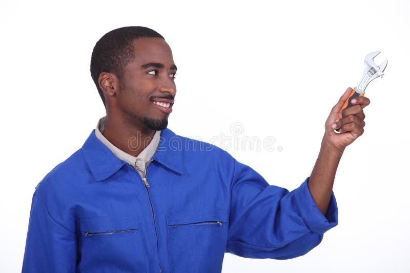 Tradesman holding spanner, stock photo. Image of male - 35520826