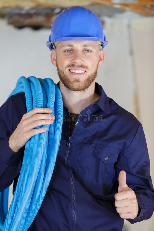 Tradesman with Reel Cable on Shoulder Giving Thumbs Up Stock Photo ...