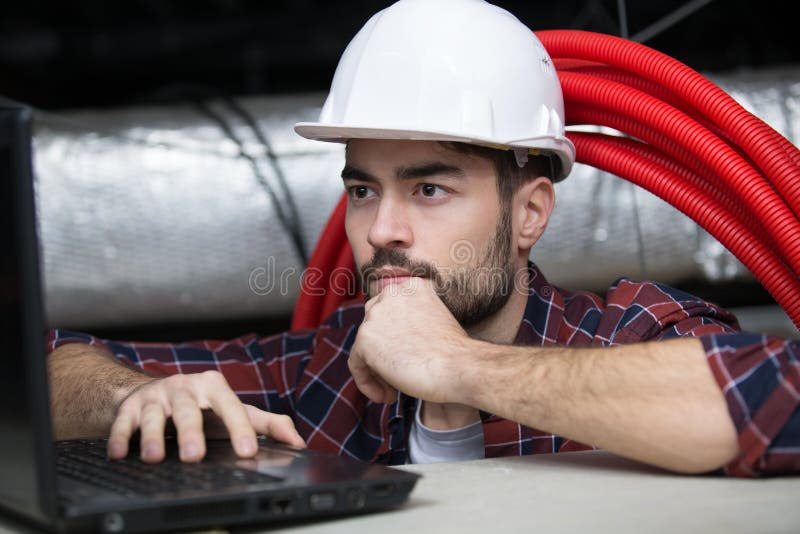 Tradesman in Roof Space Using Laptop Stock Image - Image of electricity ...