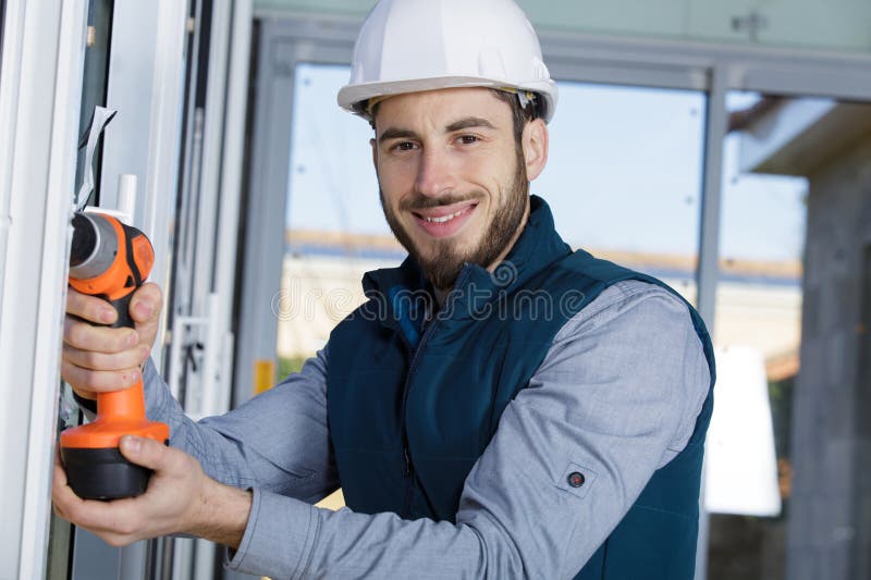 Tradesman Using Cordless Drill Stock Photo - Image of property ...