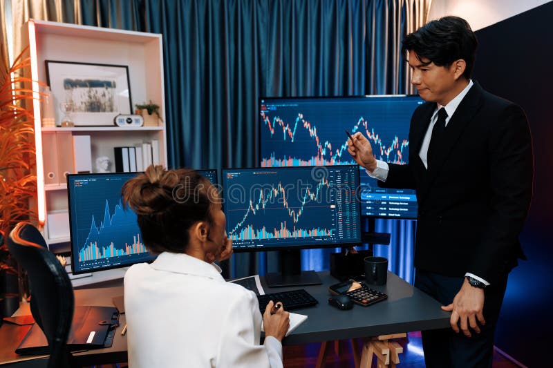 Trading Business Partners Discussing Stock on Pc Taking Note on Paper ...