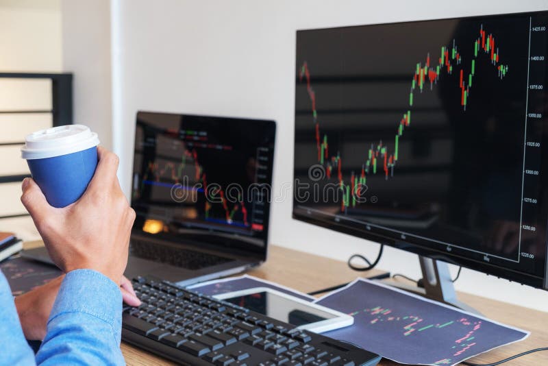 Trading on the Table is Working on a Computer Screen Full of Charts and ...