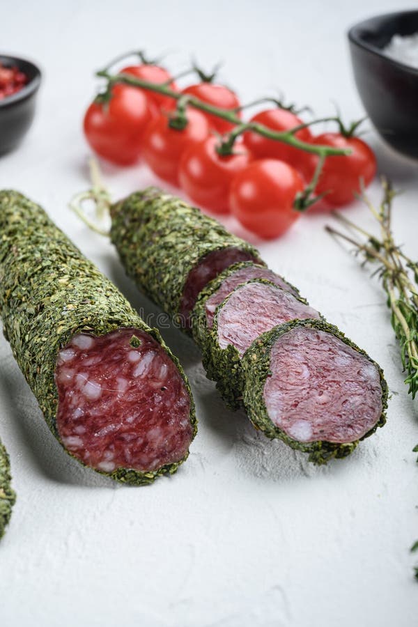 Traditianal Fuet Sausage in Herbs with Ingredients on White Surface ...