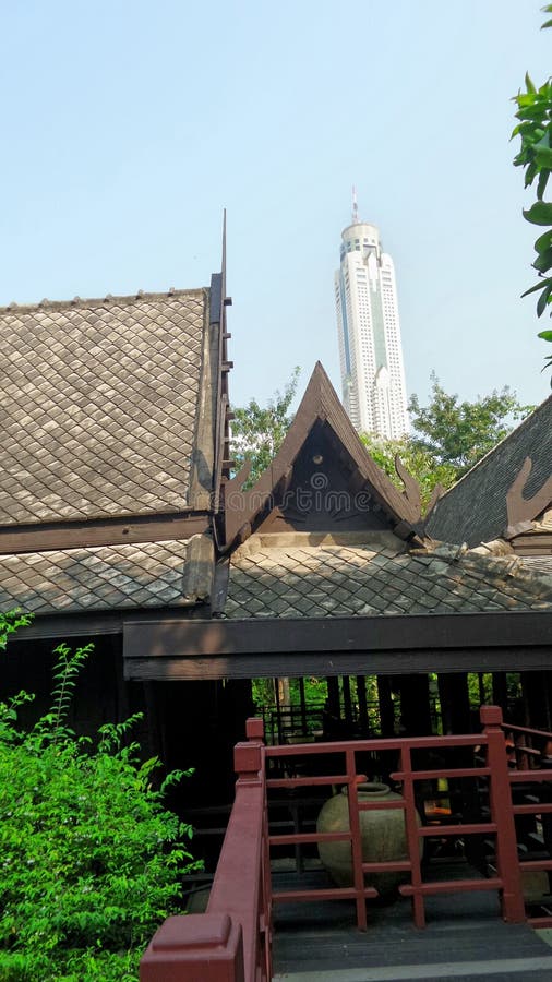 Tradition Thai House and the Modern Building Stock Photo - Image of ...