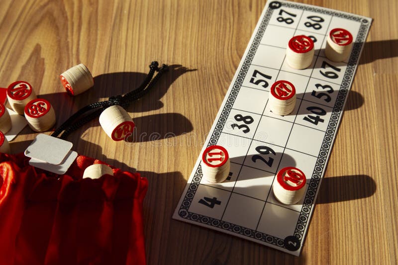 Traditional Bingo Cards and Counters on Wooden Table in Sunlight Stock ...